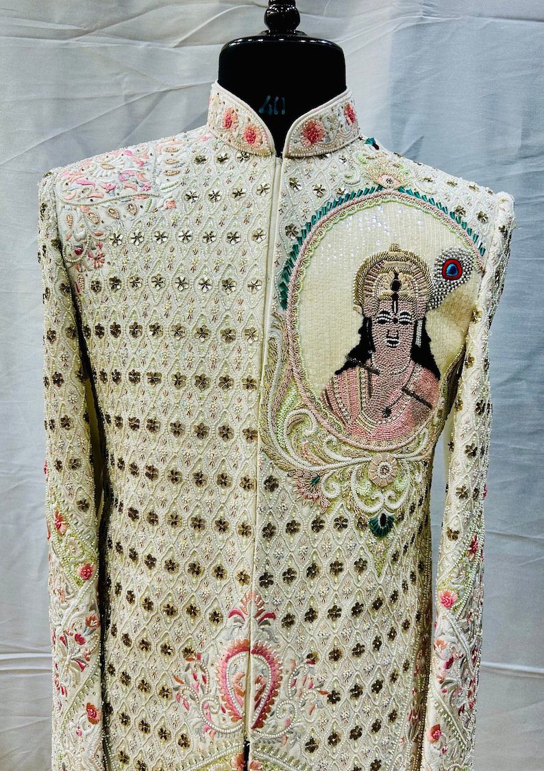 Ivory colored silk sherwani embroidered with a motif of Sri Radhe ...